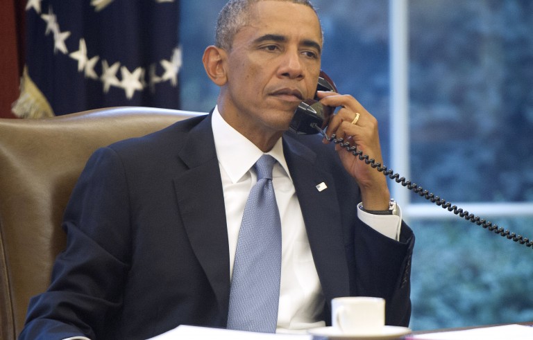 President Obama Works In The Oval Office Of White House